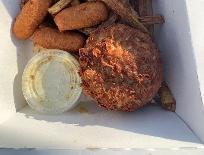 The holy grail of Maryland cuisine: a proper crab cake with minimal filler and maximum flavor. Paired with hush puppies, it's the state's culinary anthem on a plate.