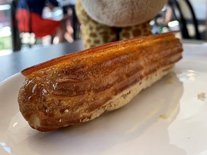 Golden, flaky, and impossibly buttery—this éclair isn't just pastry, it's edible architecture that crackles with promise at first bite.
