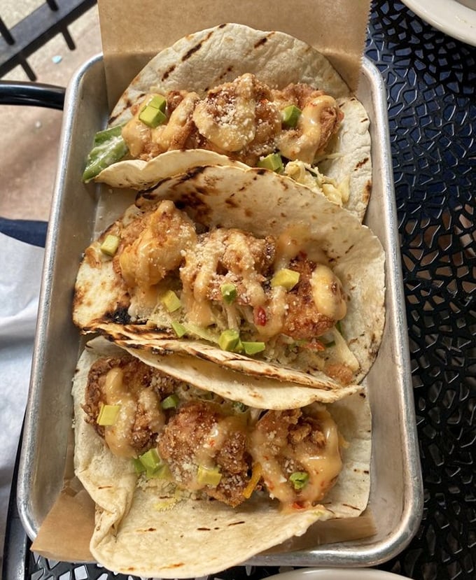 These shrimp tacos aren't just dinner, they're edible architecture—crispy, saucy towers of seafood that demand to be photographed before they're devoured.