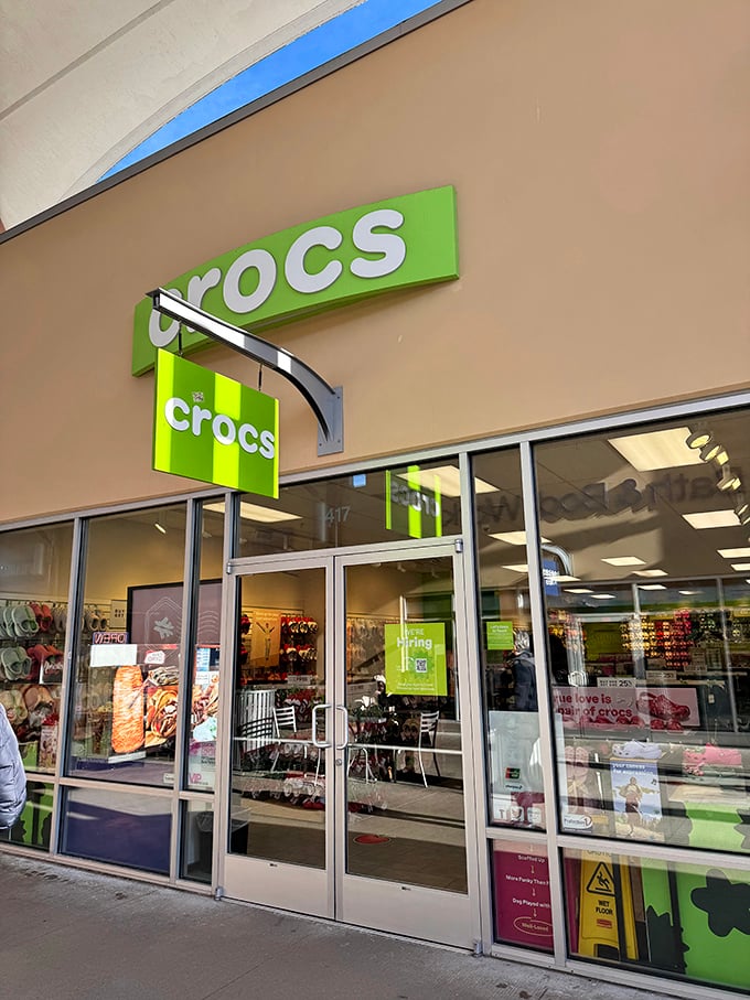 The lime-green Crocs storefront is like a beacon of comfortable rebellion—where practical footwear meets unexpected style at outlet prices. 