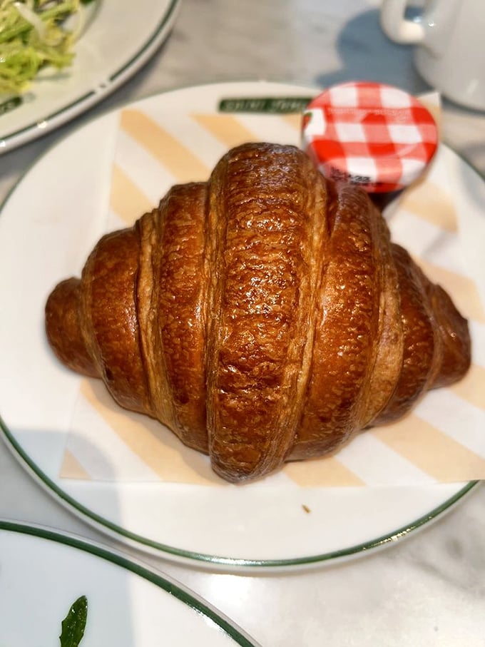 That croissant isn't just baked—it's been coaxed into golden, buttery perfection through what I can only assume is some form of French pastry whispering.