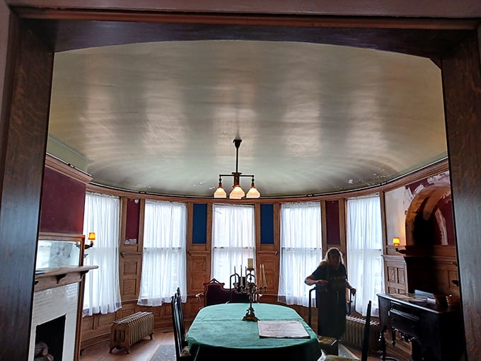The curved bay dining room, with its period-perfect blue walls and delicate light fixture, practically begs for a formal dinner party with witty conversation.