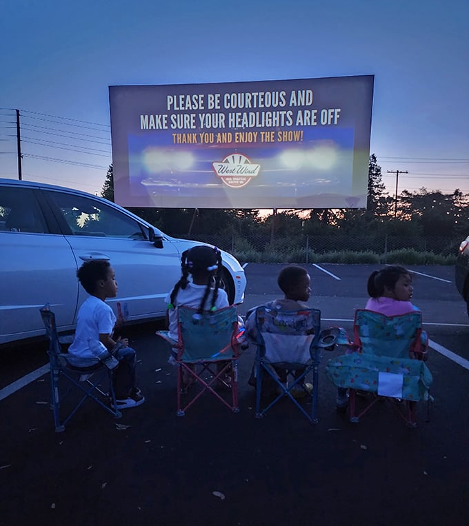 Family movie night reimagined—kids in colorful chairs experience the magic their grandparents once knew. Some traditions just refuse to fade to black.