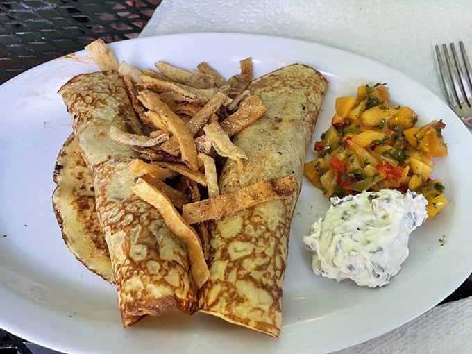 These aren't your grandmother's crepes (unless she was a culinary genius). Golden pancakes wrapped around savory duck with crispy wonton strips – pure magic.