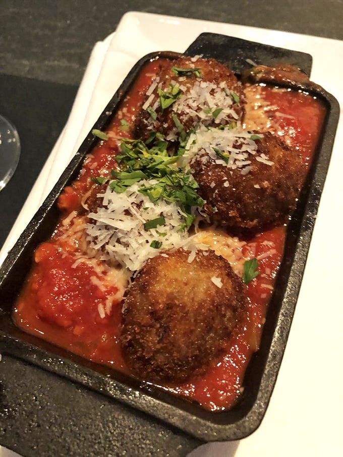 These aren't your nonna's meatballs—they're eggplant-based flavor bombs swimming in bright marinara. The shaved Parmesan on top melts just enough to make you swoon.