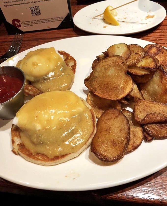 Eggs Benedict done right – perfectly poached eggs draped in hollandaise that's rich enough to need its own tax bracket. Those home fries deserve their own fan club.