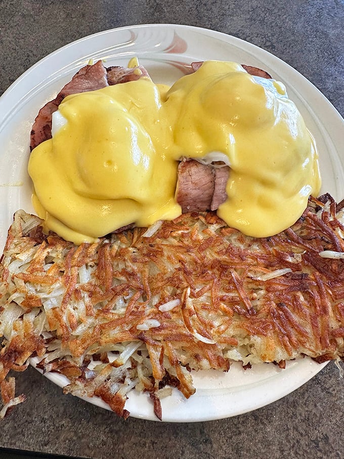 Eggs Benedict done right—crispy hash browns, perfectly poached eggs, and hollandaise sauce that would make a French chef nod in approval.