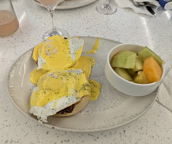 Eggs Benedict done right – perfectly poached eggs wearing sunny hollandaise jackets atop a throne of English muffins.