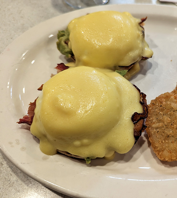 Eggs Benedict done right is like finding the perfect pair of comfortable shoes—rare, wonderful, and worth showing off. That hollandaise looks like liquid sunshine.