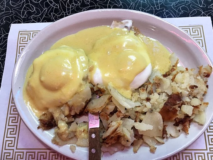 Eggs Benedict that would make the Pope jealous. That hollandaise sauce is practically liquid gold cascading over poached perfection.