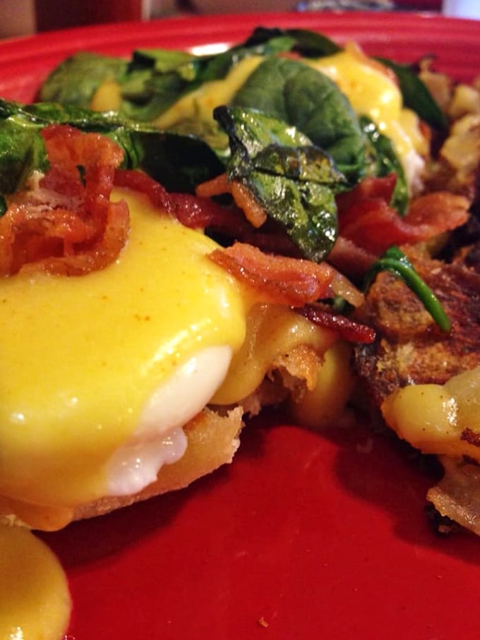 Eggs Benedict with a spinach and bacon twist. That hollandaise sauce is practically performing a victory lap around the plate.
