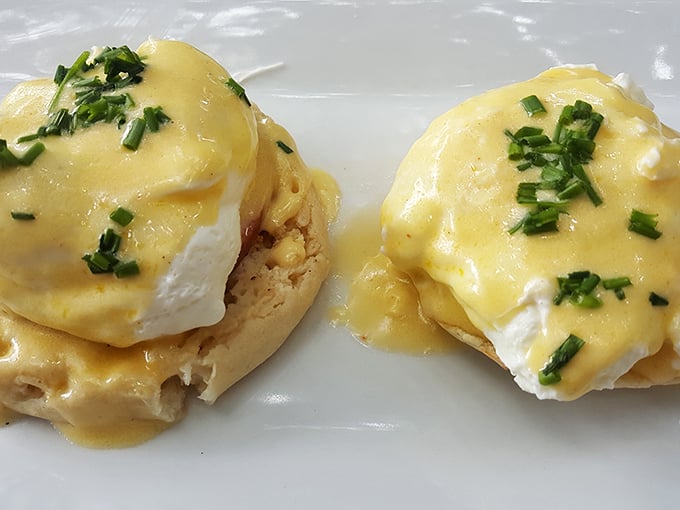 Eggs Benedict so perfectly executed, the hollandaise sauce cascades like a yellow waterfall of buttery goodness. Poached egg perfection!