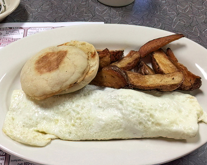 This isn't just breakfast—it's a morning masterpiece featuring a perfectly toasted English muffin, fluffy eggs, and home fries that deserve their own fan club.