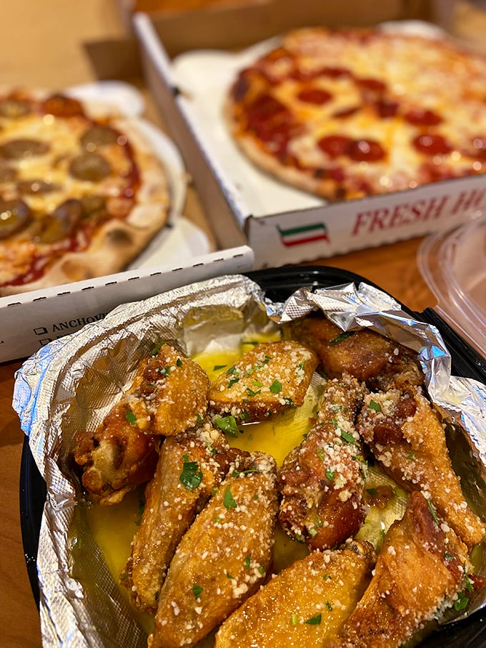 The holy trinity of pizza perfection: two personal pies and garlic knots dusted with parmesan that would make an Italian grandmother weep with joy.