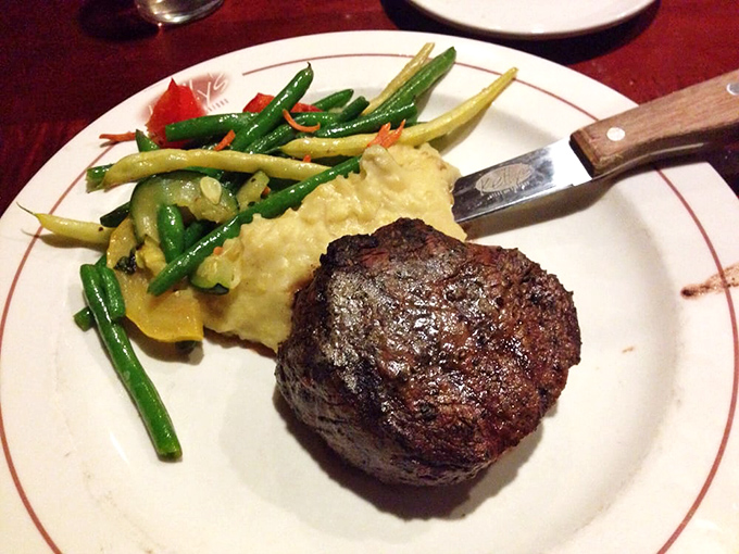 This filet mignon isn't just cooked—it's been treated with the respect a prime cut deserves, accompanied by creamy mashed potatoes and vibrant green beans.