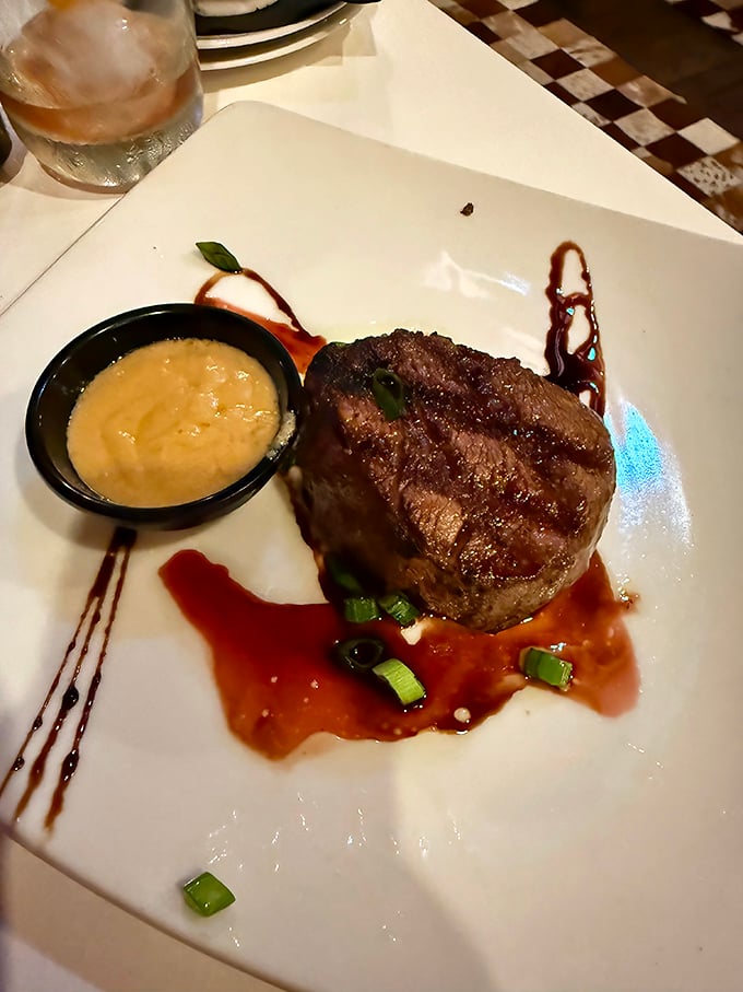 This filet mignon isn't just cooked—it's been sweet-talked to perfection, resting in a pool of sauce that you'll want to collect with a spoon.
