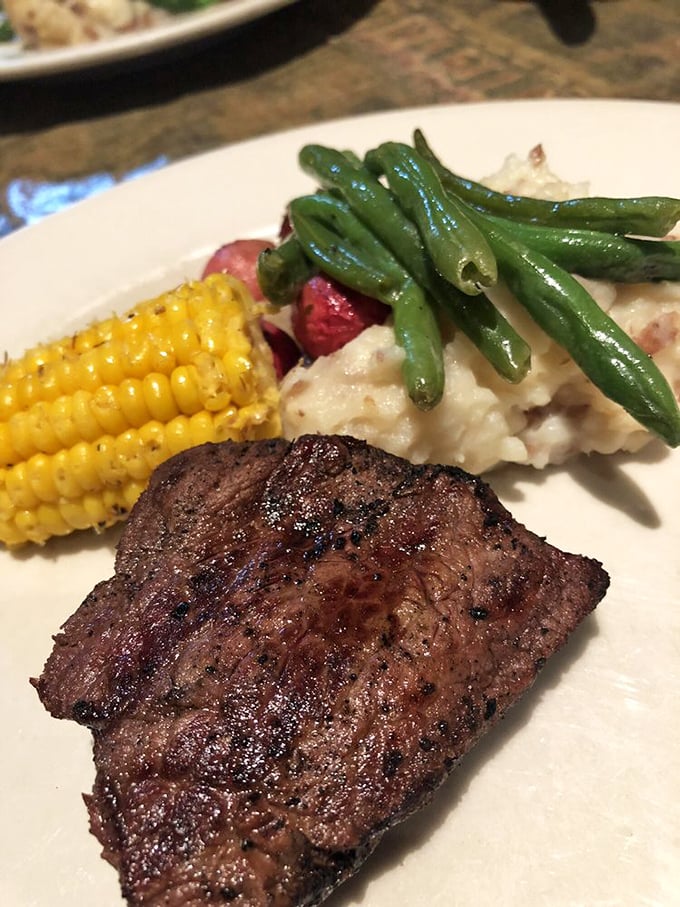 Steak perfection alongside corn and green beans – proof that classics endure for good reason. The holy trinity of American comfort.