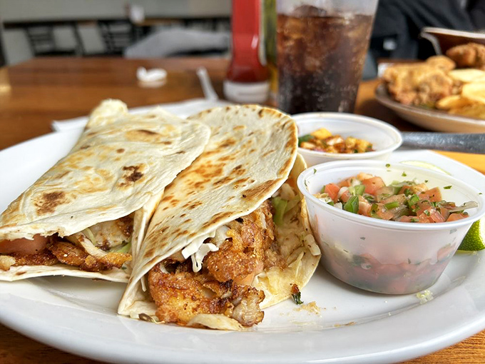 These fish tacos aren't just lunch—they're a coastal vacation wrapped in a tortilla. Fresh pico de gallo stands ready to elevate each bite.