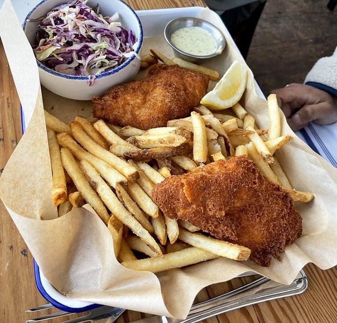 Fish and chips that achieve the golden ratio of crispy exterior to flaky interior. The coleslaw adds that perfect tangy counterpoint. 