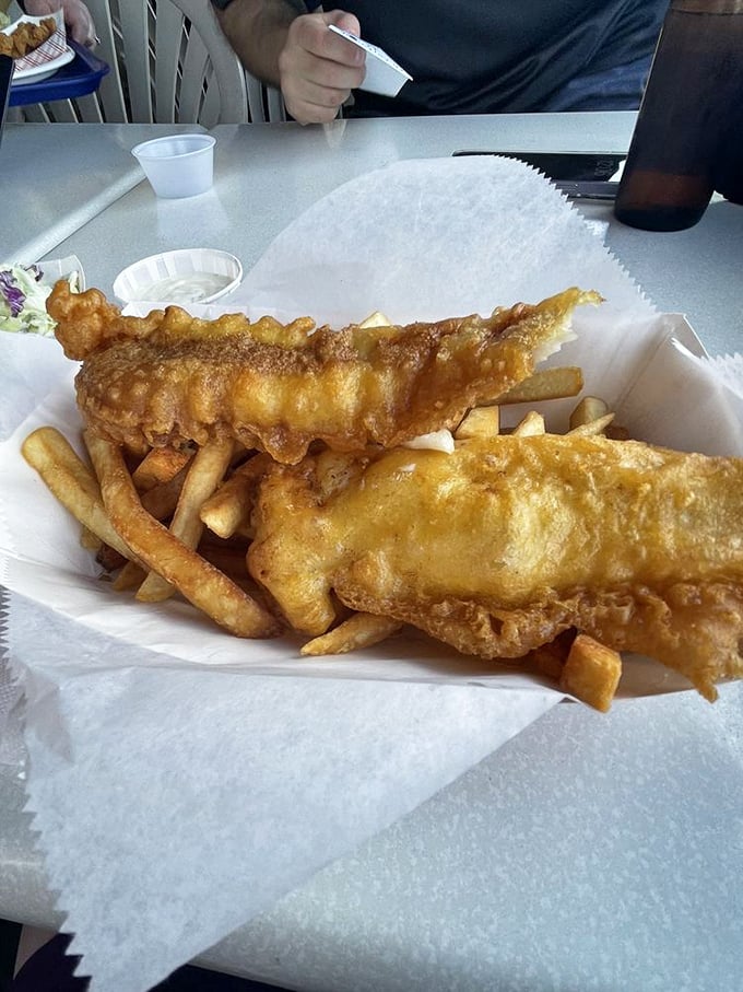 Golden-battered fish and crispy fries—the classic duo that launched a thousand ships and satisfied countless hungry sailors and landlubbers alike.
