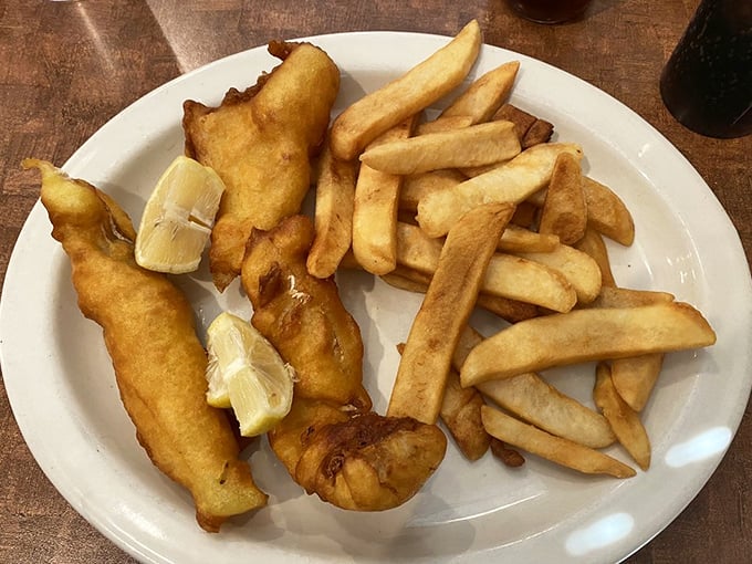 Fish and chips that would make a British pub jealous – golden, crispy batter protecting flaky white fish alongside perfectly cooked fries.