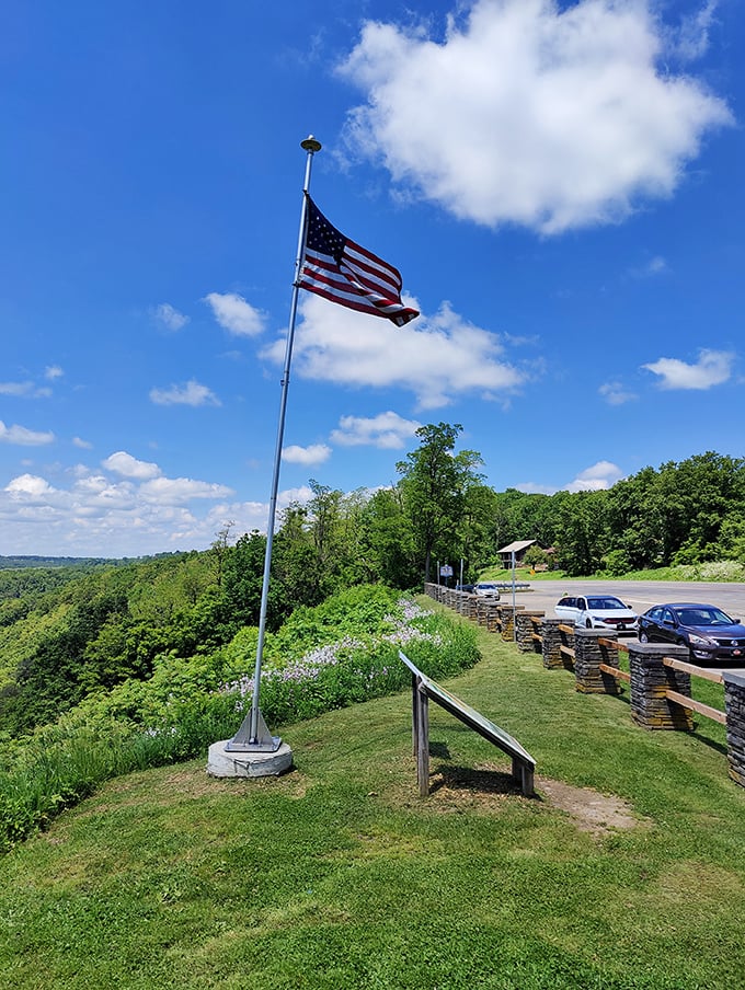 Old Glory waves hello against azure skies, welcoming visitors to one of Pennsylvania's most jaw-dropping natural balconies.