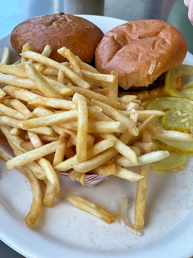 Golden fries, crisp pickles, and sliders in perfect harmony—a plate that proves simplicity is the ultimate sophistication in comfort food.