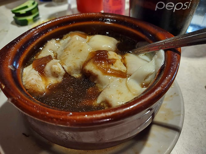 French onion soup that doesn't mess around – a hearty crock of savory broth, tender bread, and melted cheese that demands a moment of silence.
