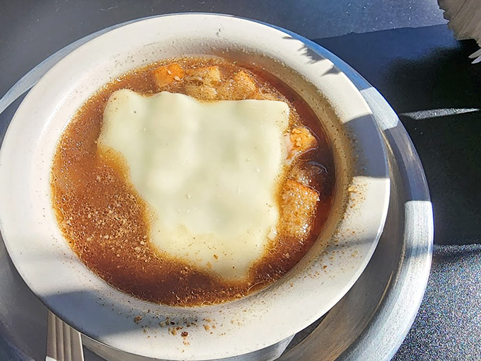 French onion soup that doesn't mess around – a rich broth crowned with a blanket of melted cheese that stretches with each spoonful.