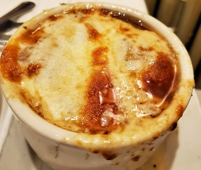 French onion soup with a cheese blanket so perfect, it could win a beauty pageant for melted dairy.
