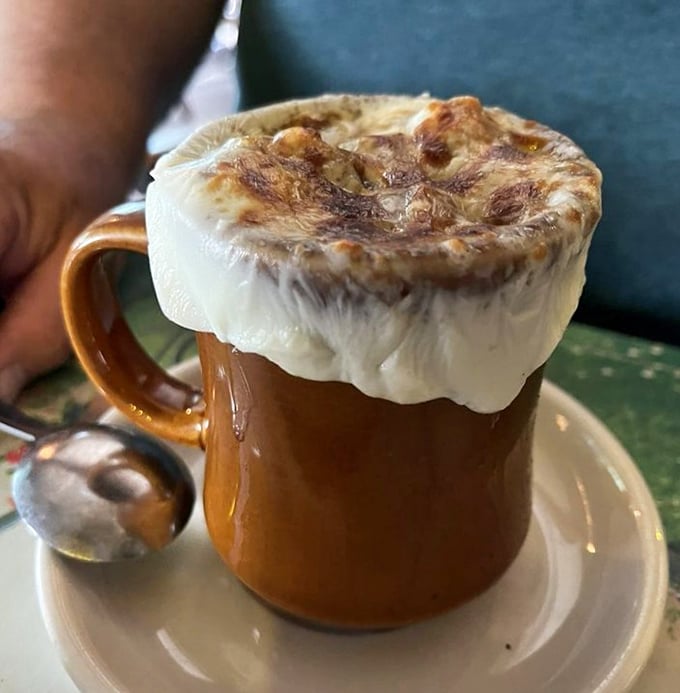 This isn't just French onion soup—it's a cheese-crowned masterpiece that requires a commitment. The relationship starts with a spoon and ends with stretchy, glorious strings.