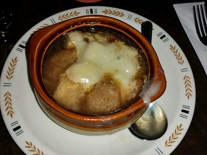 French onion soup that doesn't mess around—the cheese pull alone deserves its own highlight reel in the Comfort Food Hall of Fame.