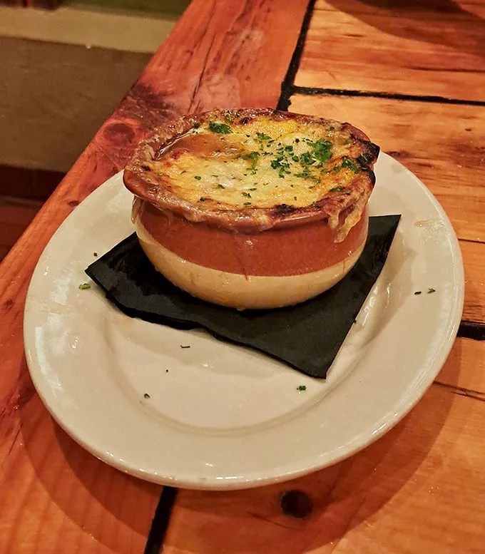 This isn't just French onion soup—it's a cheese-capped cauldron of comfort that your grandmother would approve of, if your grandmother was Julia Child.