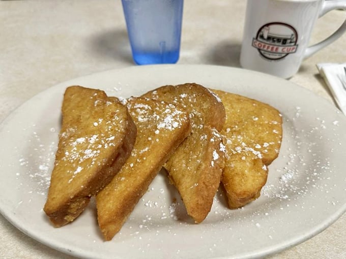French toast that doesn't need a passport to impress – golden, crispy edges, dusted with powdered sugar, and waiting patiently for your maple syrup baptism.