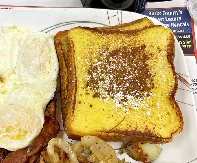 This French toast isn't just golden—it's retirement-fund golden. Powdered sugar dusted like memories of simpler, sweeter times.
