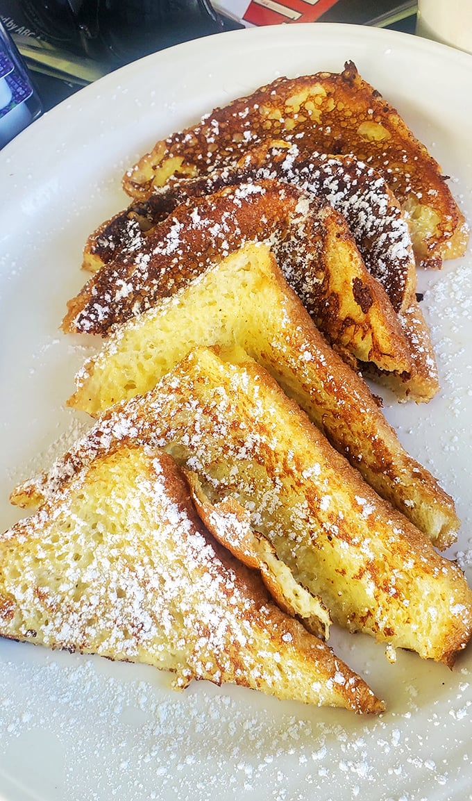 French toast that makes you question why you ever bothered with cereal—golden, custardy, and dusted with powdered sugar like fresh Pennsylvania snow.