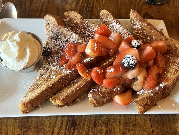 French toast that makes you question your life choices—why haven't you been eating this every day? Those berries aren't garnish; they're little jewels of morning joy.