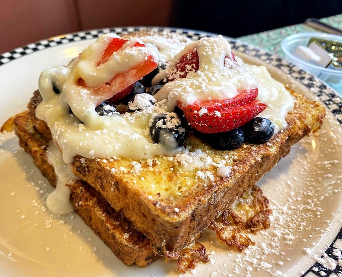 The French toast doesn't just arrive—it makes an entrance. Fresh berries and cream transform bread into something that belongs in the Louvre of breakfast.