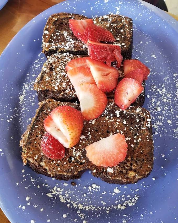 French toast that's had a spa day – exfoliated with cinnamon, moisturized with butter, and adorned with fresh strawberries and powdered sugar.