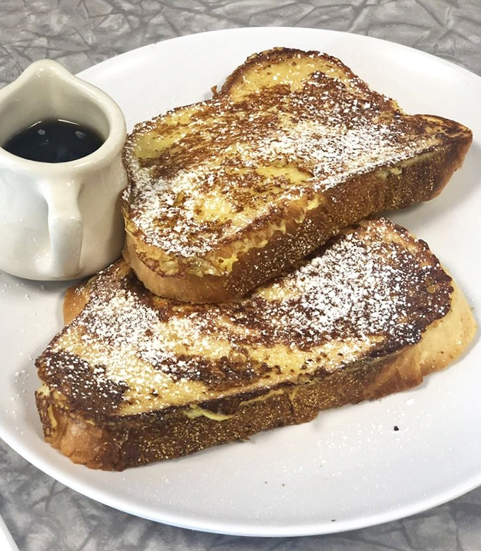 French toast that's achieved the golden ratio of crispy exterior and custardy interior. That dusting of powdered sugar isn't just pretty—it's necessary.