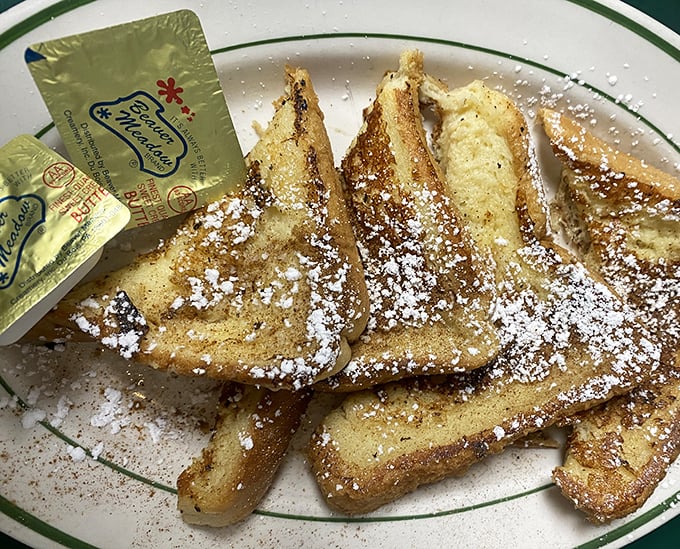 French toast triangles that would make France jealous – crispy edges, custardy centers, and enough powdered sugar to leave evidence on your shirt.