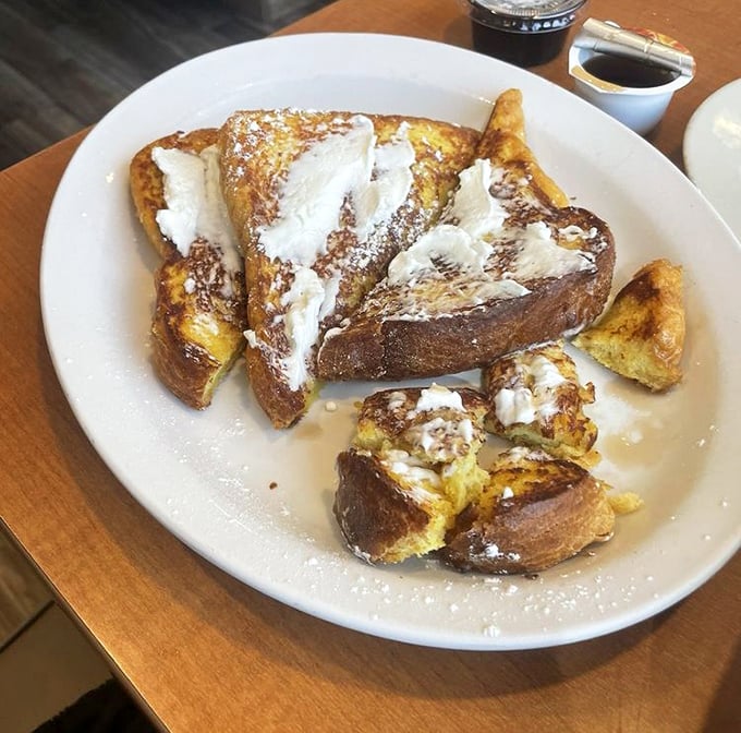 French toast that would make France jealous. Thick-cut bread transformed into a powdered sugar paradise that's both crispy and custardy in all the right places.