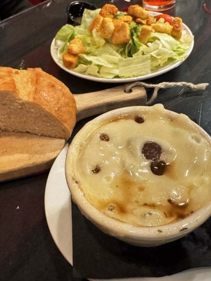 The Caesar salad and French bread aren't just supporting actors—they're preparing your palate for the meaty main event to come.