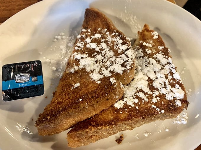French toast that doesn't need a fancy pedigree to impress—just the perfect balance of crispy exterior, custardy interior, and a snowfall of powdered sugar.