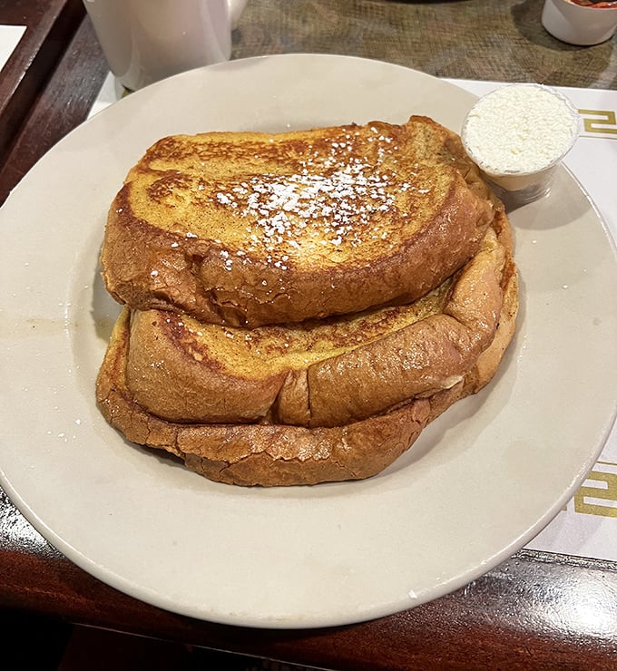 French toast that's been properly introduced to cinnamon and powdered sugar—a breakfast that doesn't know it's not dessert.