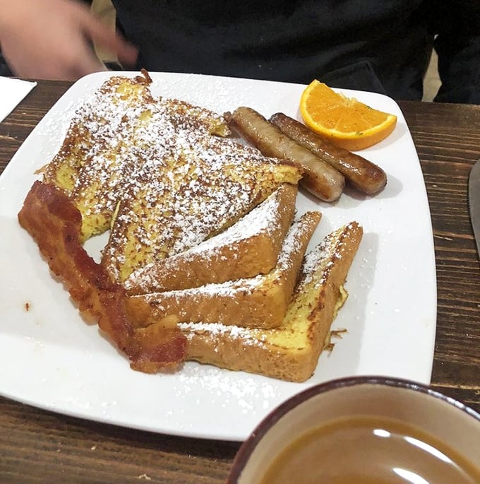 French toast that's dressed for success with powdered sugar and a side of sausage—breakfast's version of formal wear.