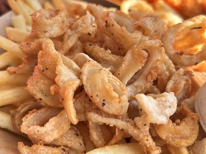These fried calamari strips aren't rubbery hockey pucks – they're tender little treasures of the sea with a perfect crispy coating.