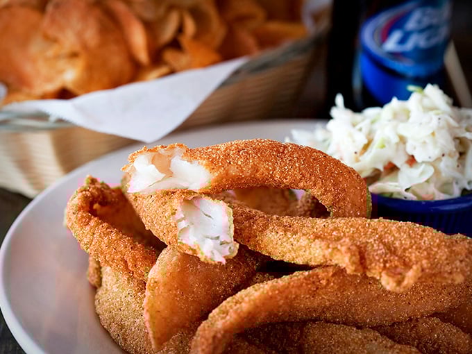 These golden-battered onion rings aren't just a side dish—they're the supporting actors that sometimes steal the whole show.