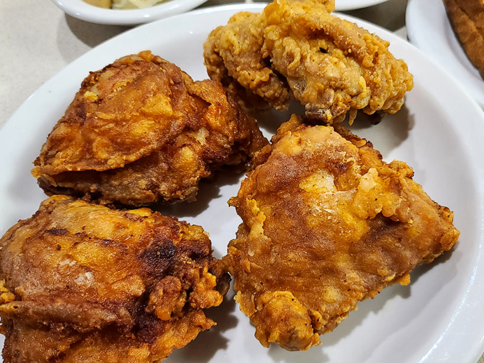Golden-brown fried chicken that crackles with each bite, revealing juicy meat beneath—Colonel Sanders would hang up his white suit in defeat.