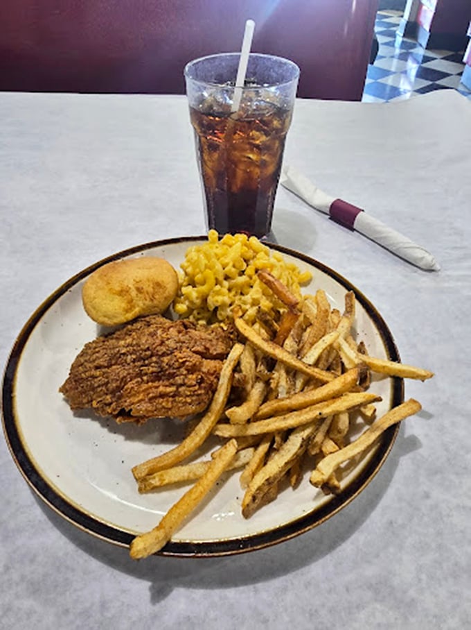 Comfort food royalty: crispy chicken, creamy mac and cheese, and golden fries—the holy trinity of Southern satisfaction that would make your cardiologist wince and your soul sing.